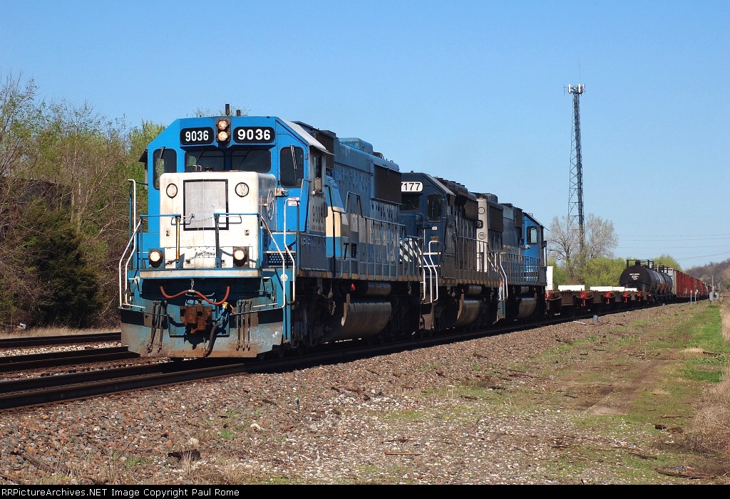EMDX 9036, Oakway Lease unit leads sister Oakway and Helm Lease unit eastbound at Holiday on the ...